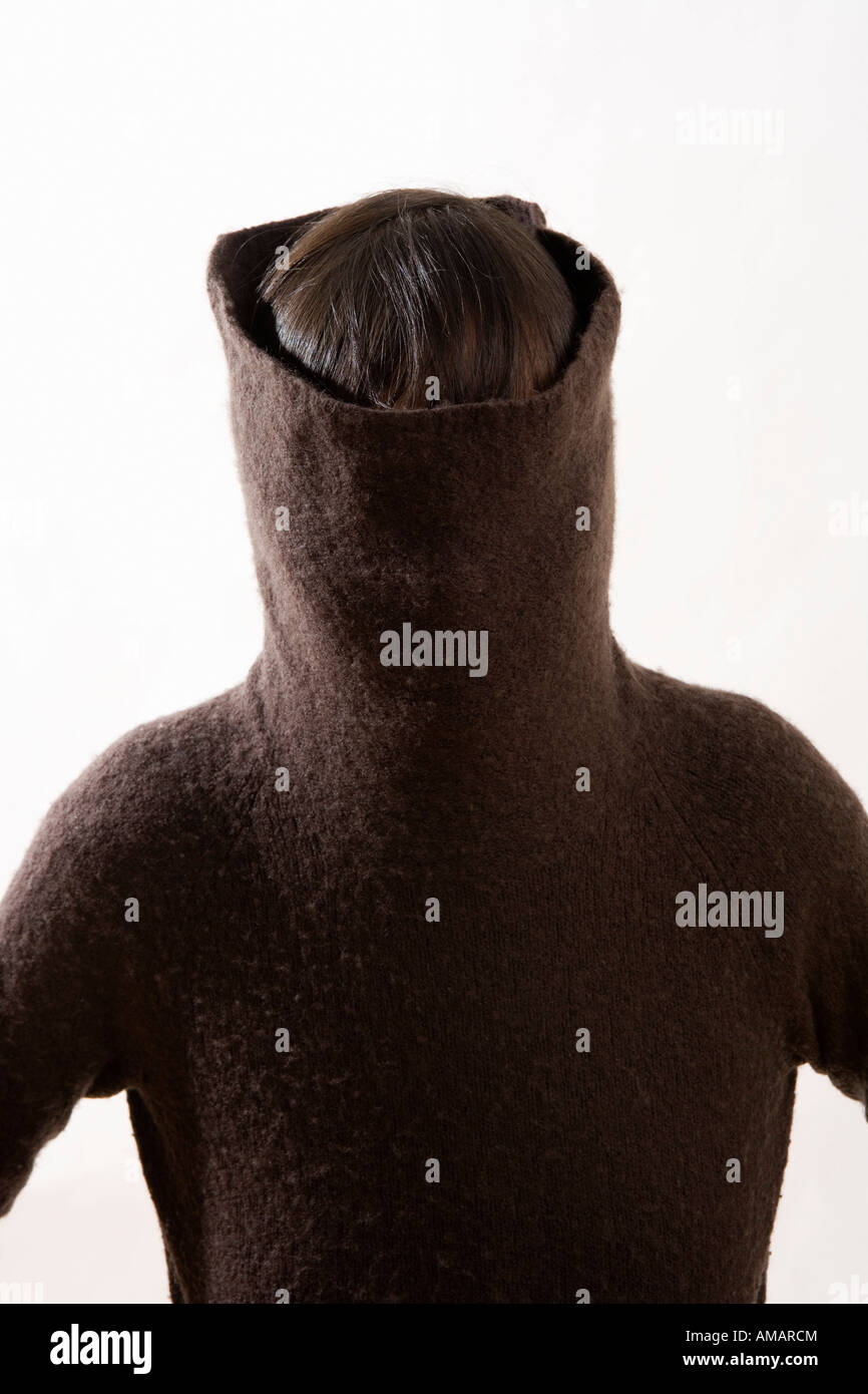 A woman pulling a turtleneck over her head Stock Photo - Alamy