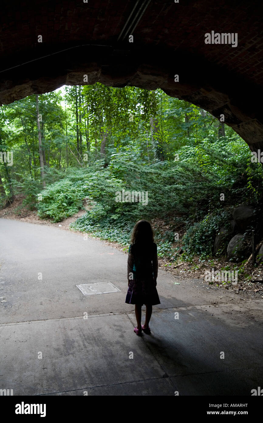 A girl standing under an archway Stock Photo - Alamy