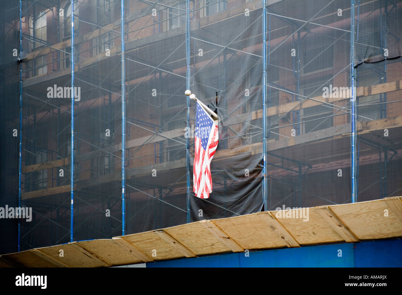 An American flag hanging between scaffolding Stock Photo - Alamy