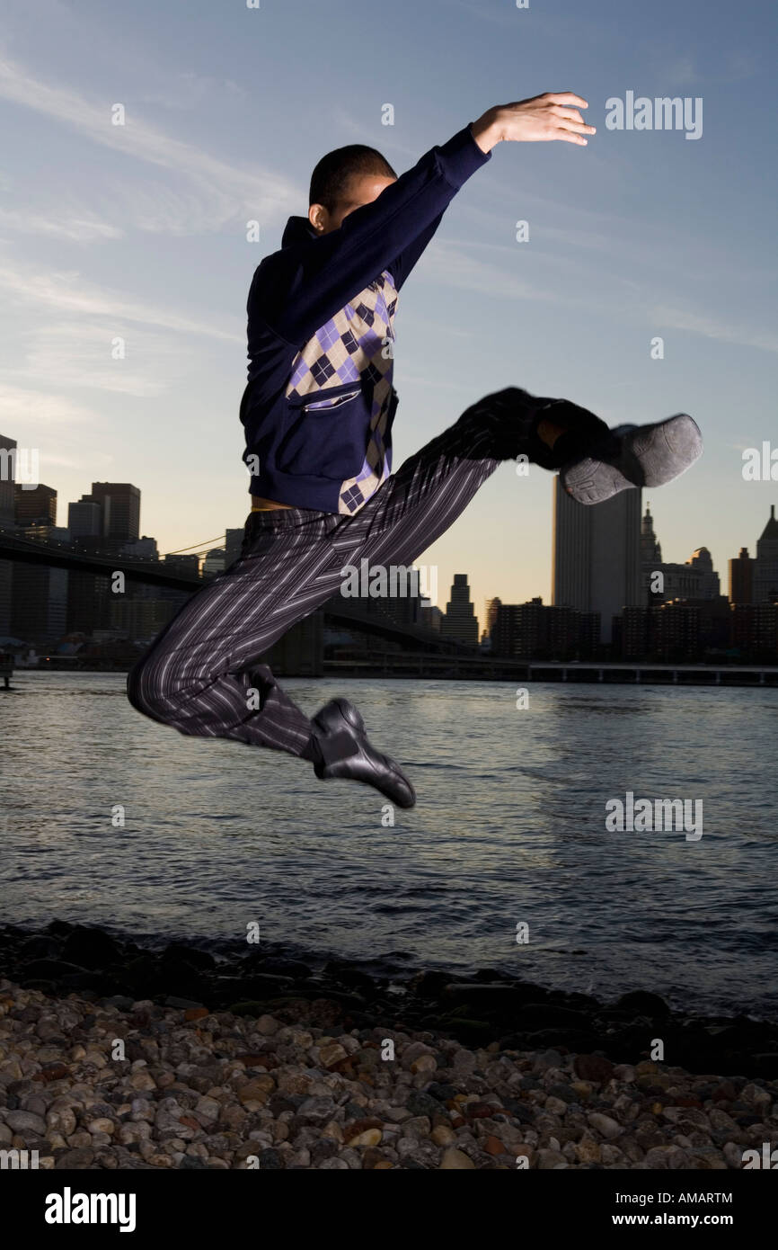 A man dancing with the Manhattan skyline behind Stock Photo - Alamy