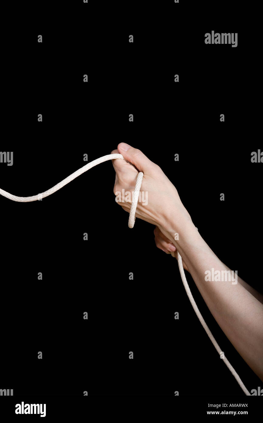 A hand holding rope Stock Photo - Alamy