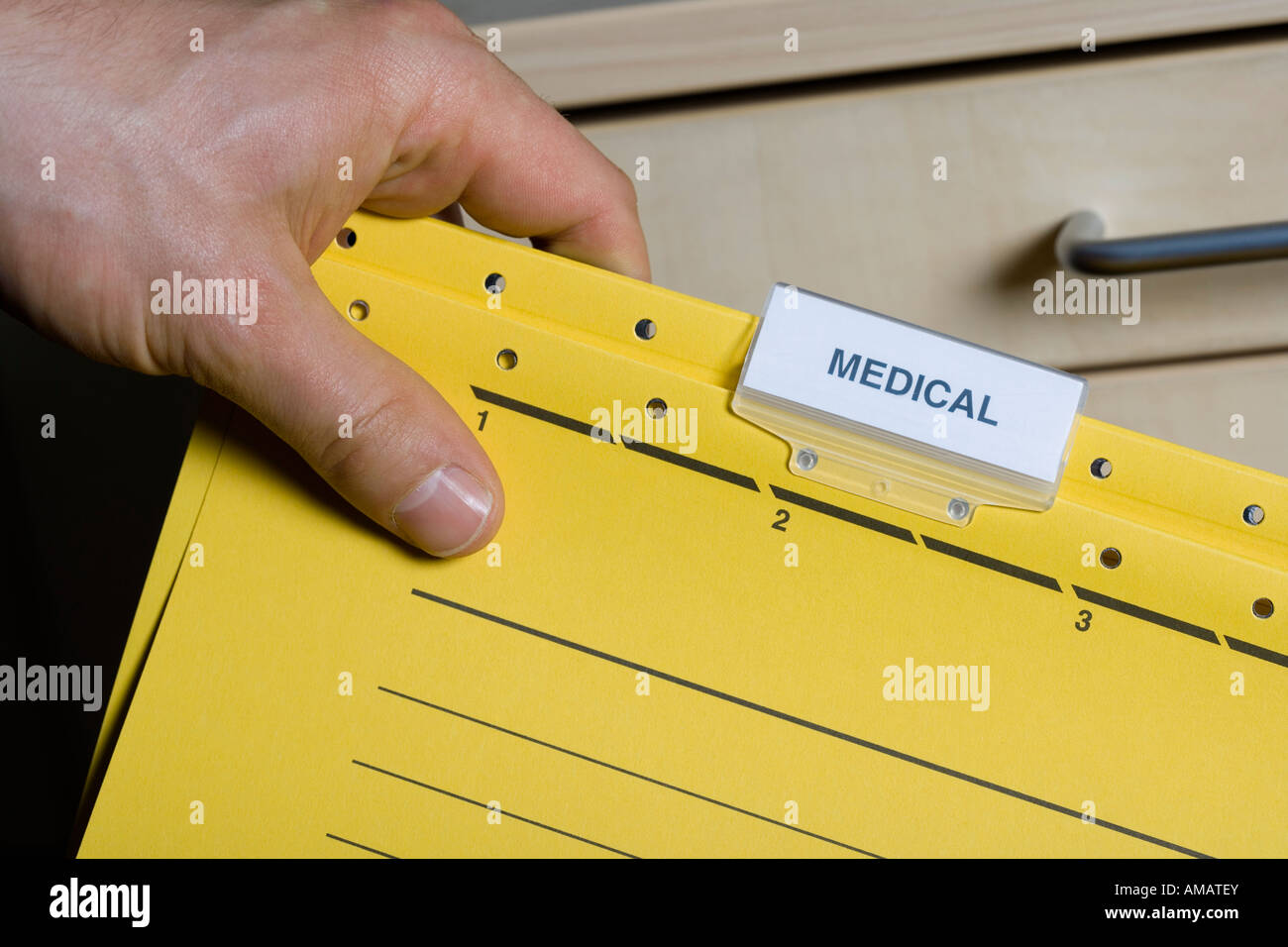 A hand picking up a file Stock Photo - Alamy