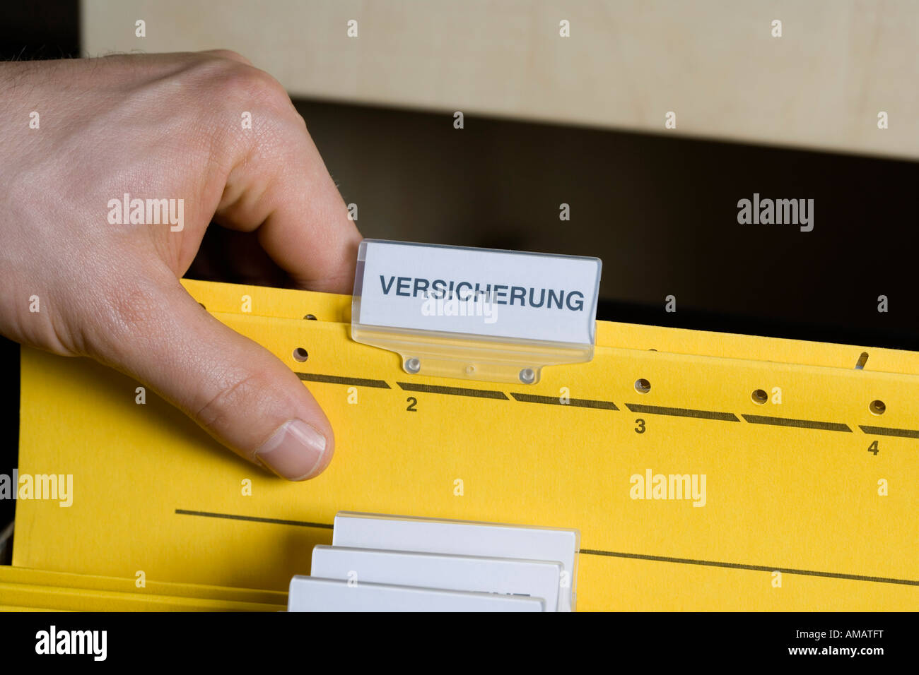 A hand picking up a file Stock Photo - Alamy