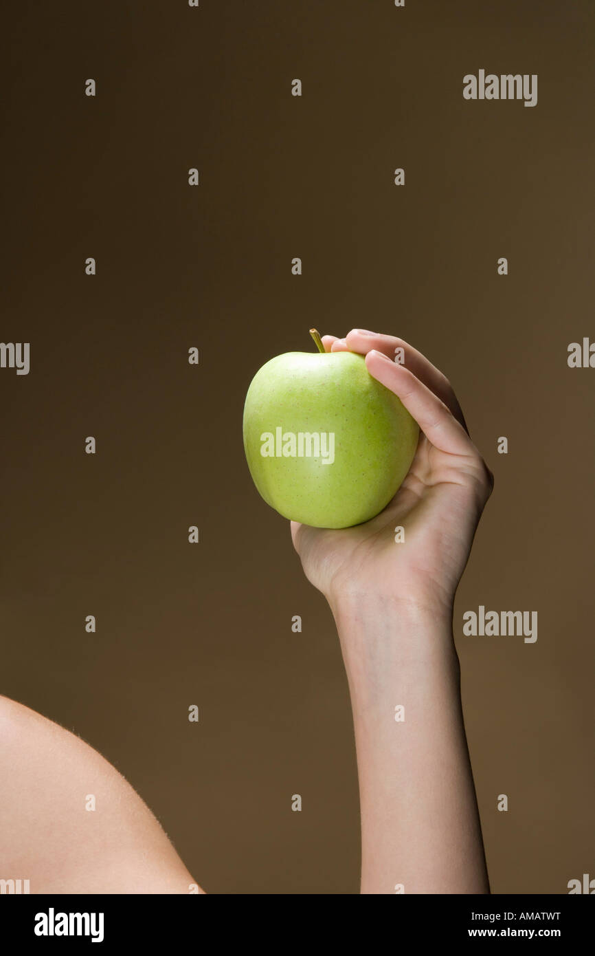 A hand holding an apple Stock Photo - Alamy