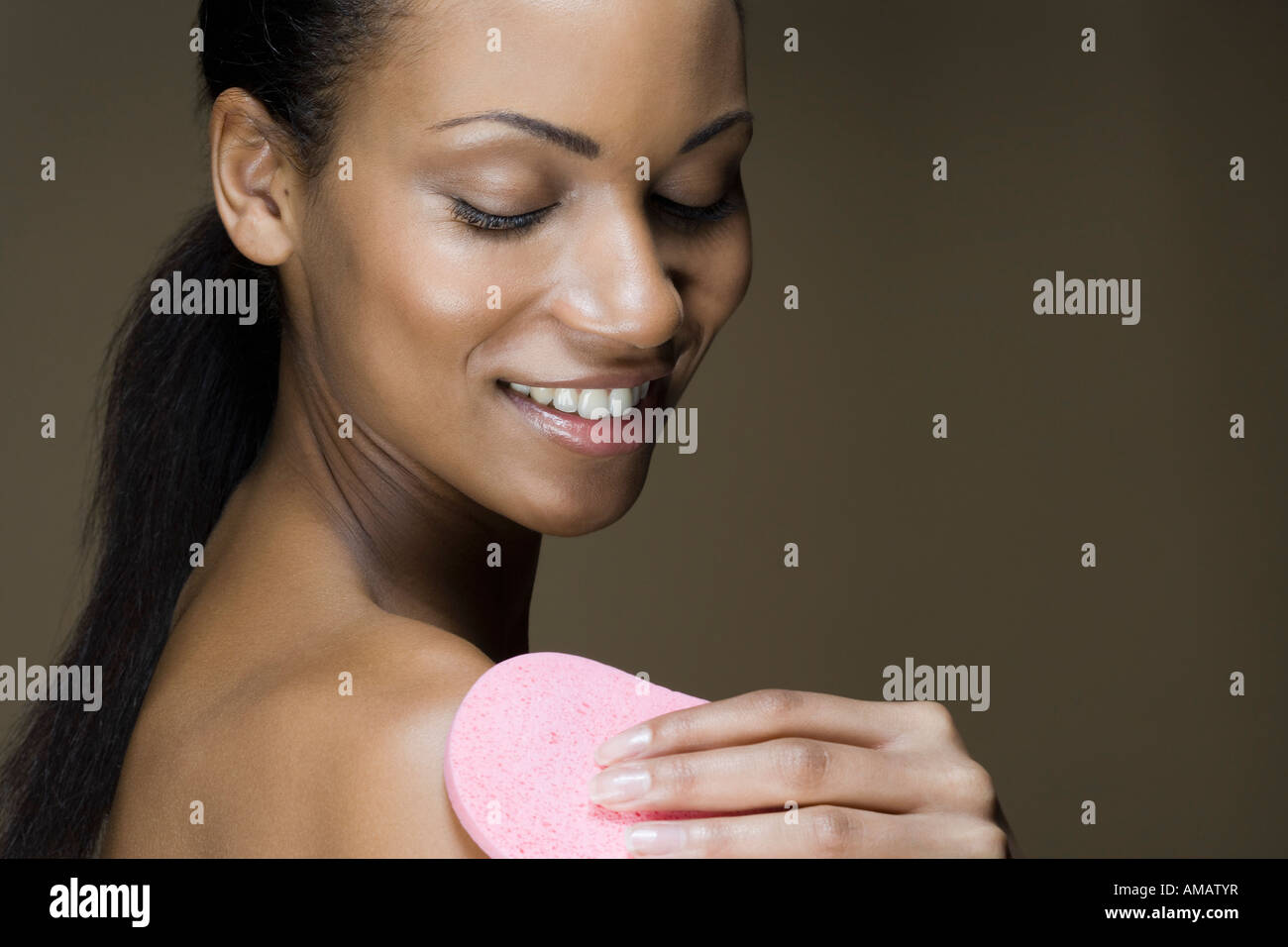 A woman using a luffa Stock Photo - Alamy