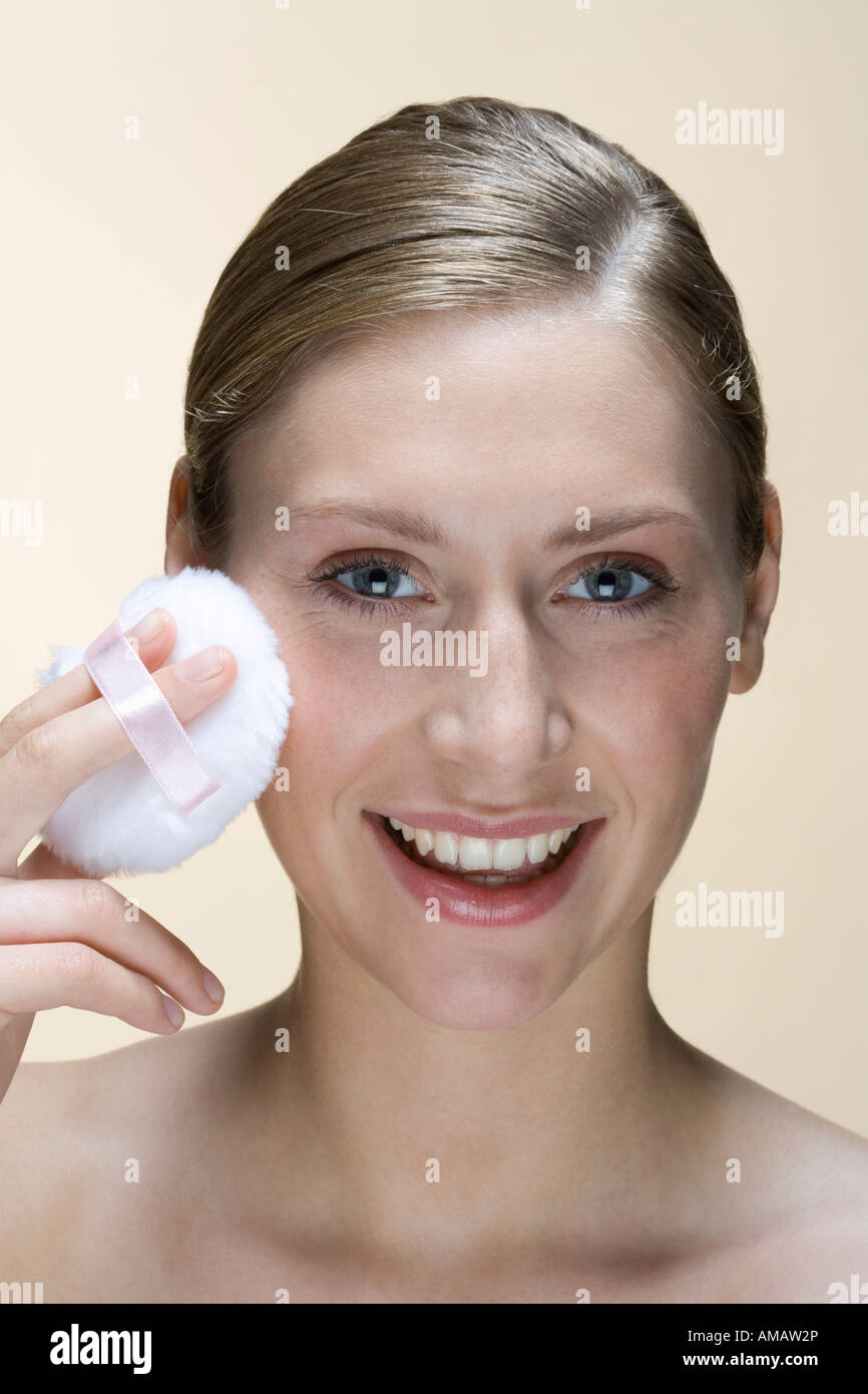 A woman holding a powder puff Stock Photo - Alamy