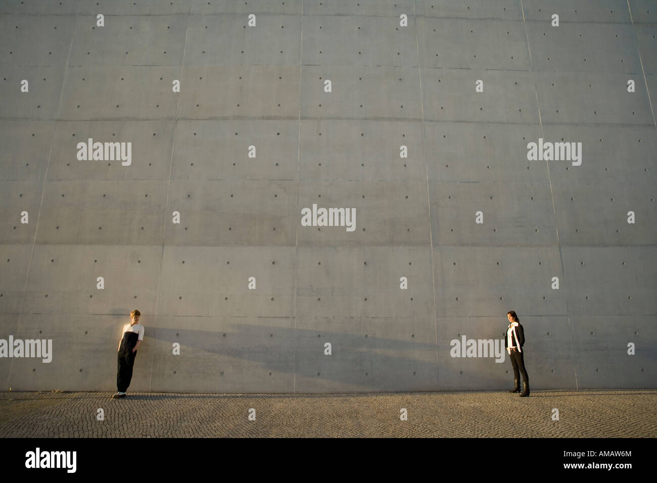 A couple standing next to wall Stock Photo - Alamy