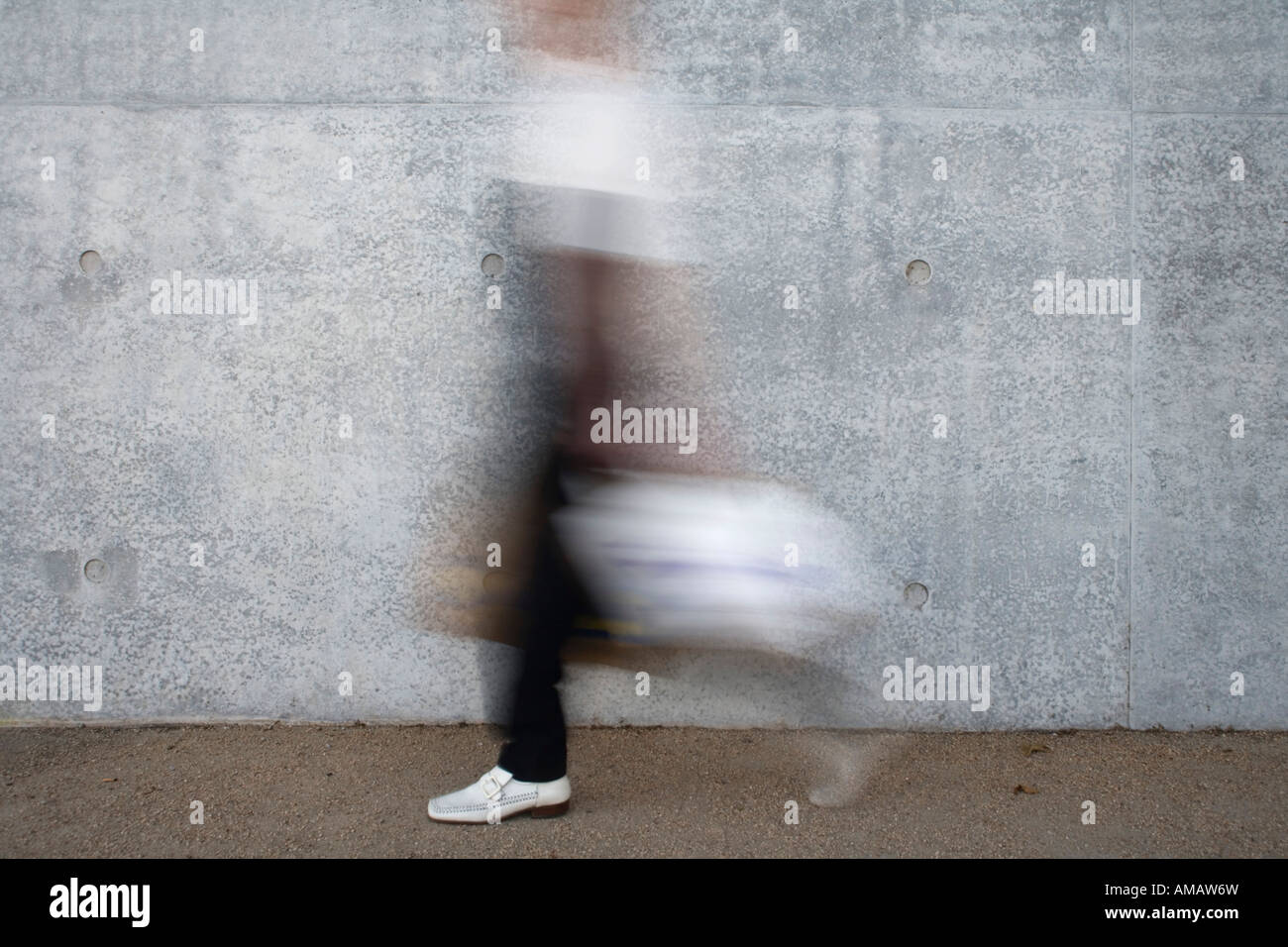 Person walking past concrete wall hi-res stock photography and images ...