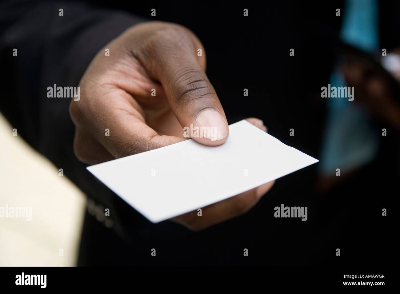 Hand holding out a blank business card Stock Photo - Alamy