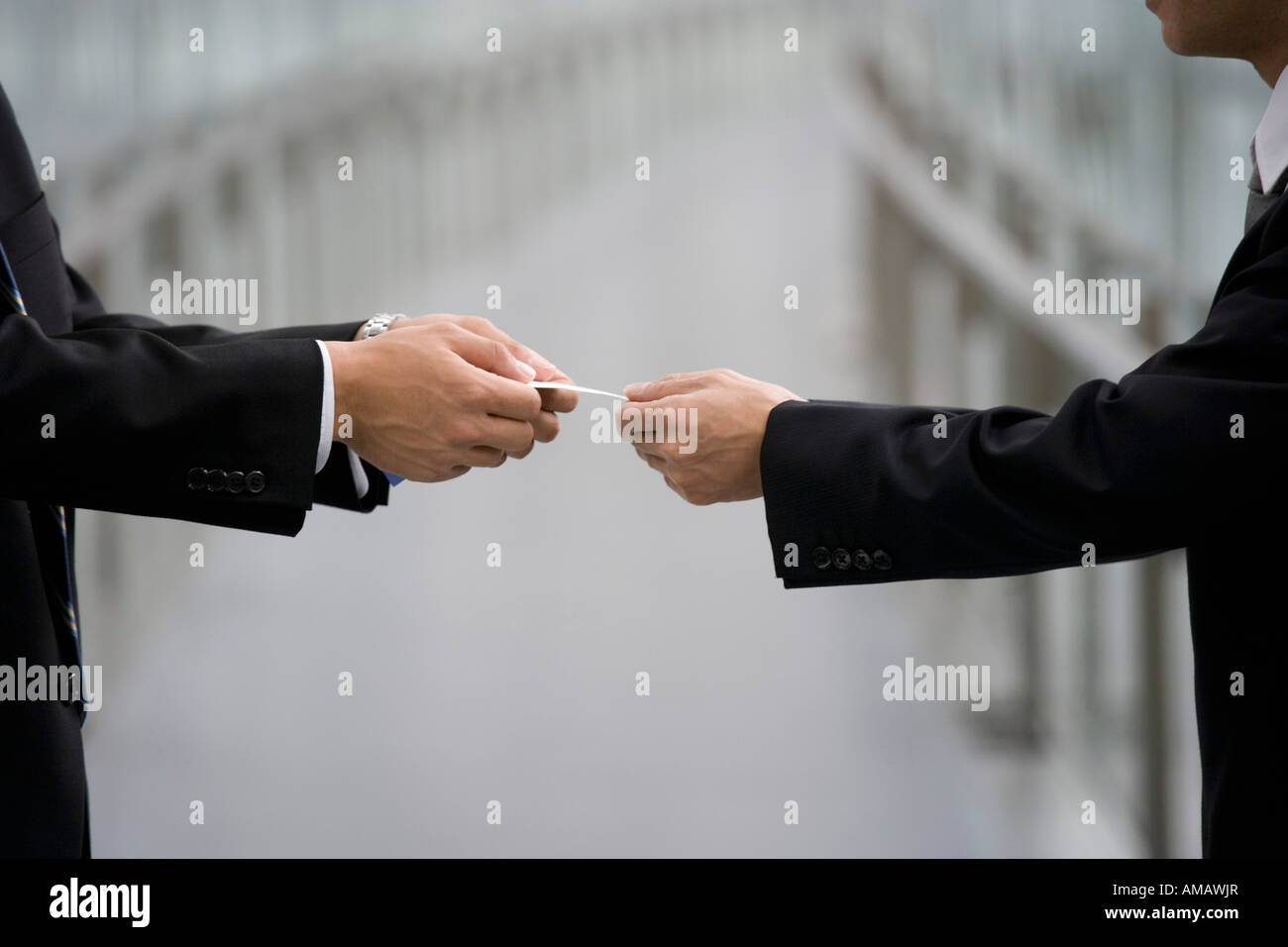 Two businessmen exchanging business card hi-res stock photography and ...