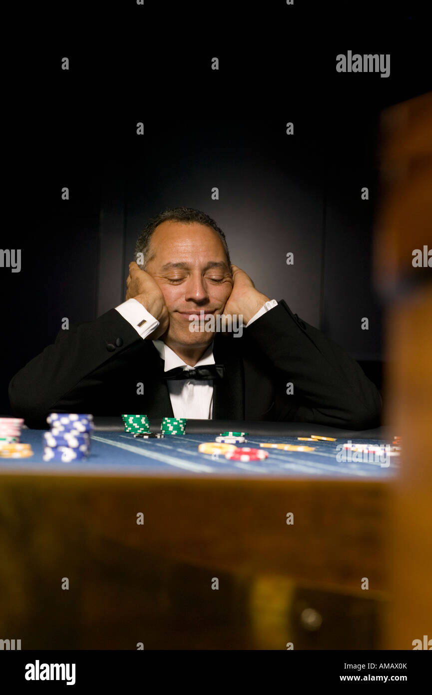 Man losing at casino table Stock Photo - Alamy