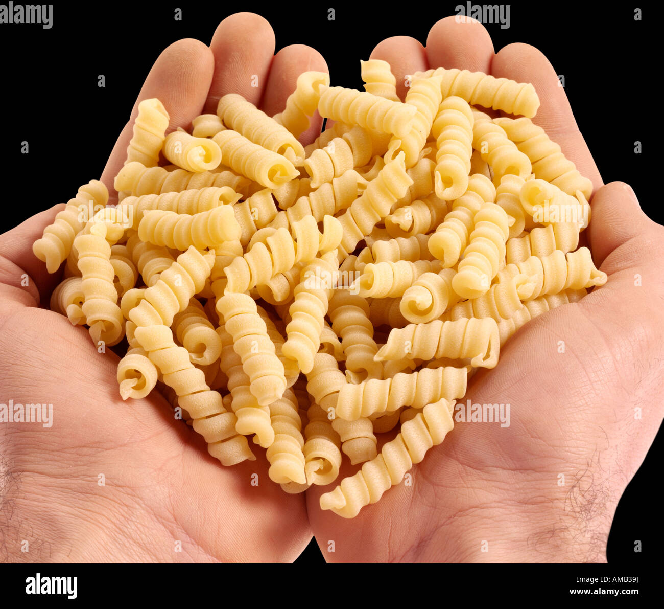 HANDFUL OF BOCCOLETTI PASTA Stock Photo - Alamy