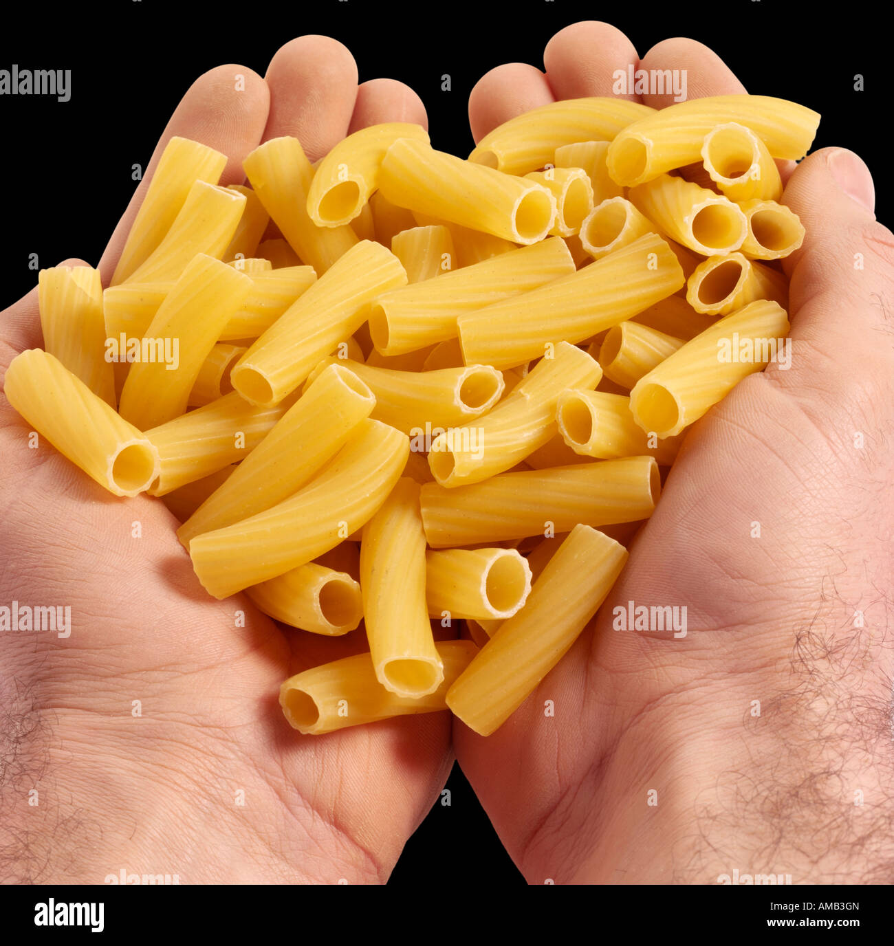 HANDFUL OF RIGATONI PASTA Stock Photo - Alamy