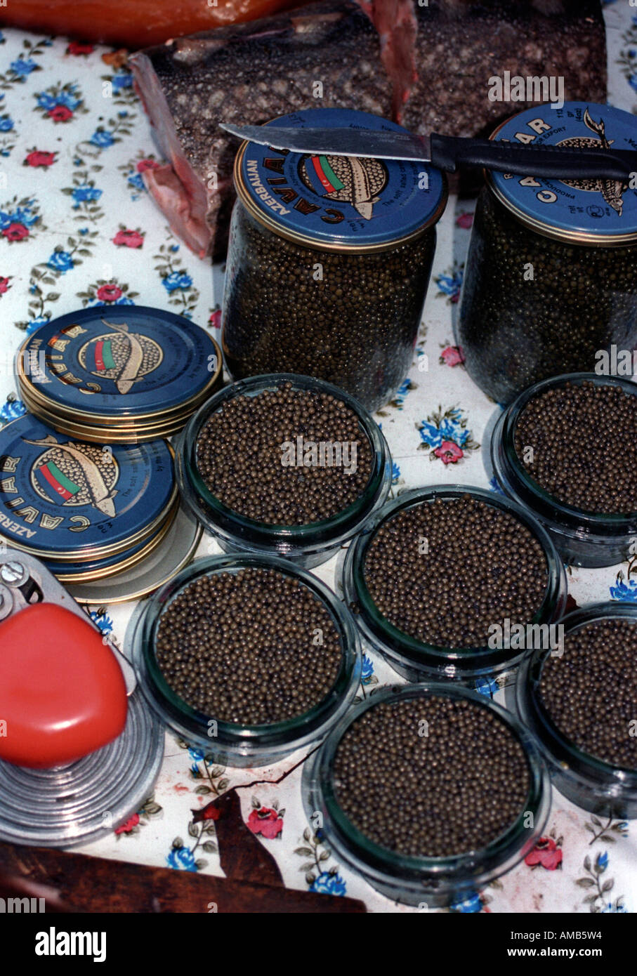 Fresh sturgeon caviar in glass jars on sale on a table in a market in ...