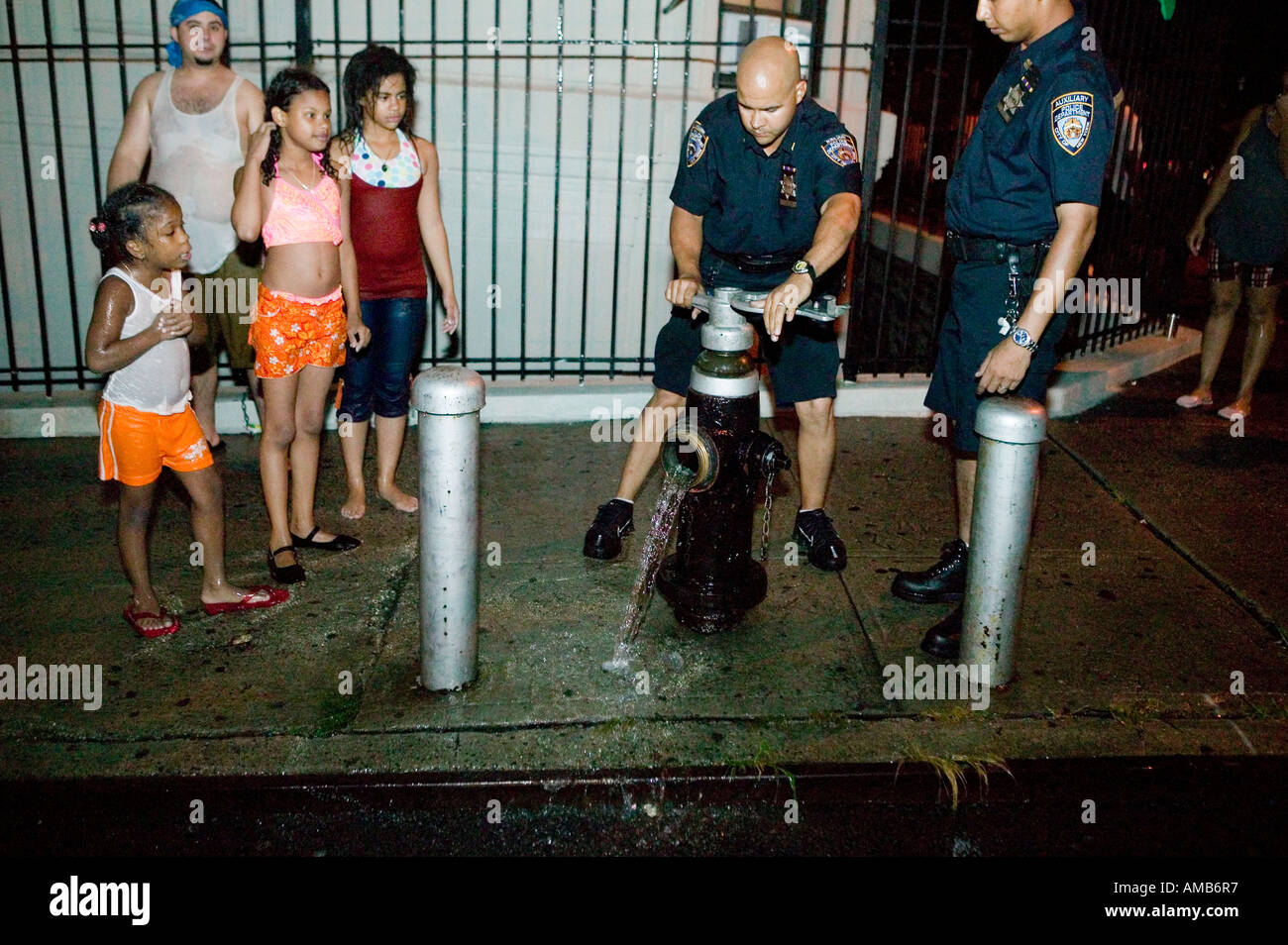 Police officers turn off an illegally opened fire hydrant in Harlem New ...