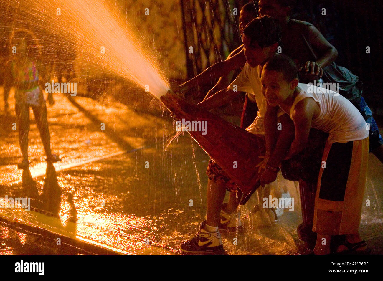 Playing in the fire hydrant spray in Harlem New York City USA August ...