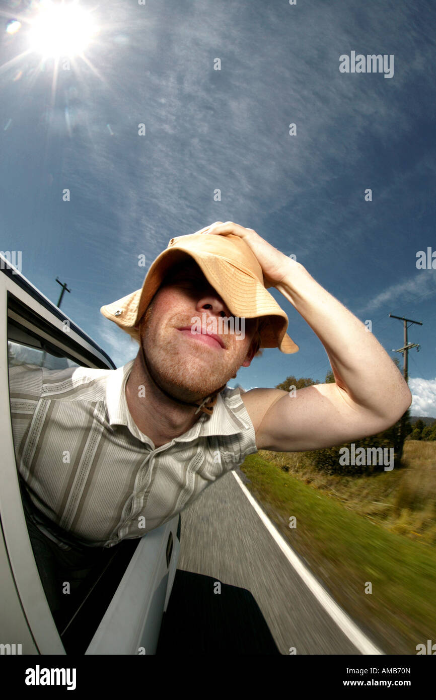 young man watching out of the window of a driving car Stock Photo - Alamy