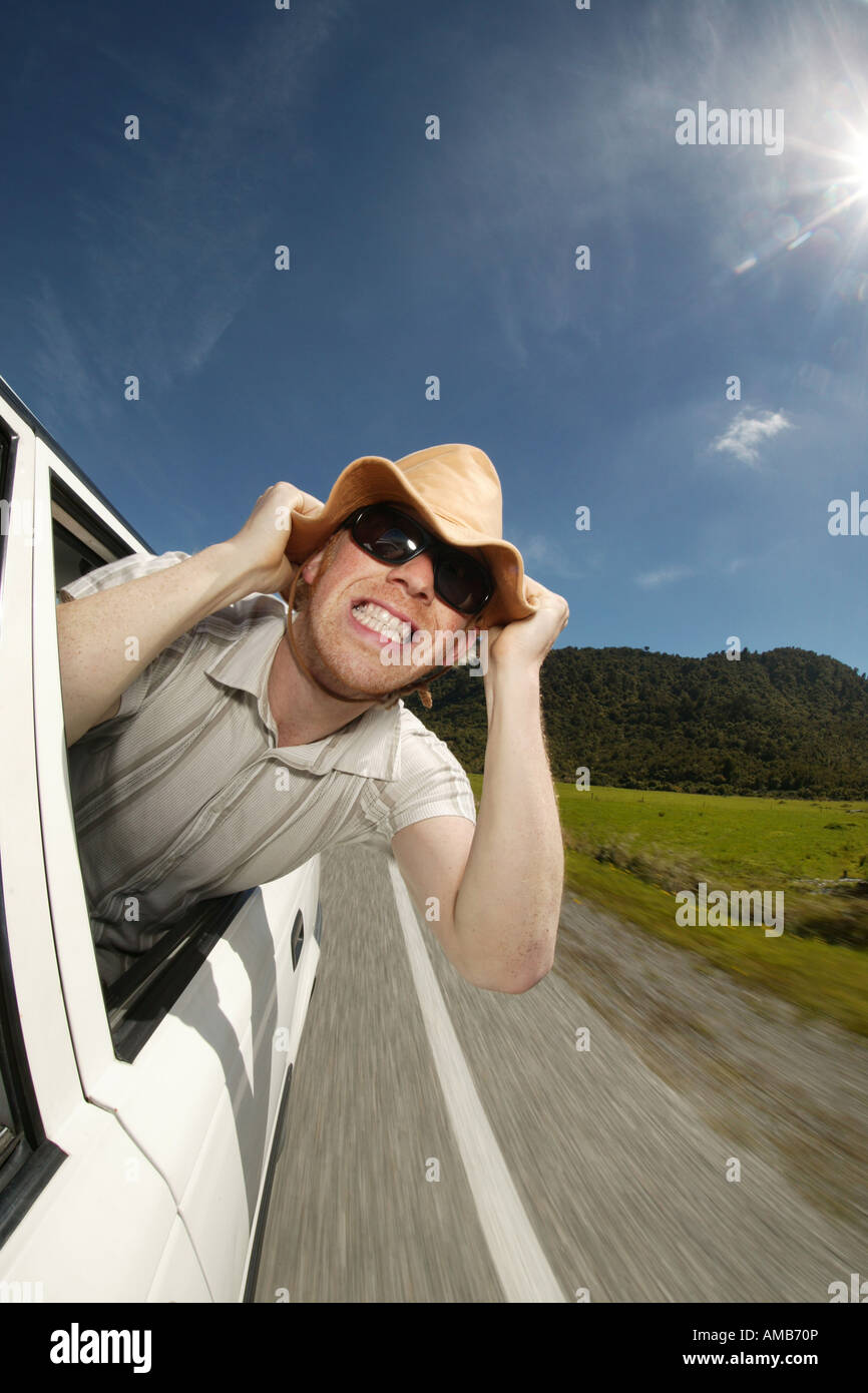 young man watching out of the window of a driving car Stock Photo - Alamy