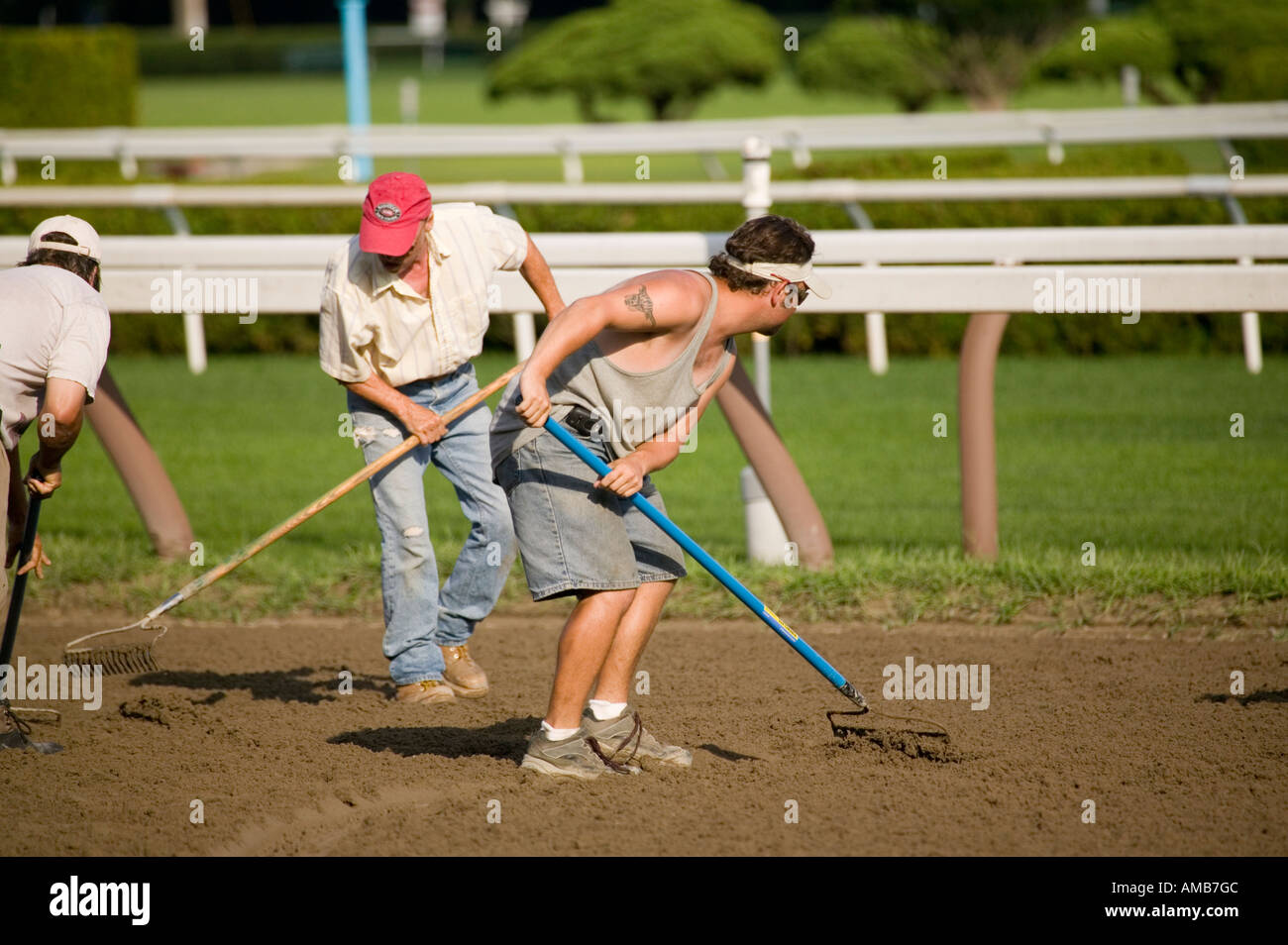 Workers rake the track after the passage of the horses at the Saratoga ...
