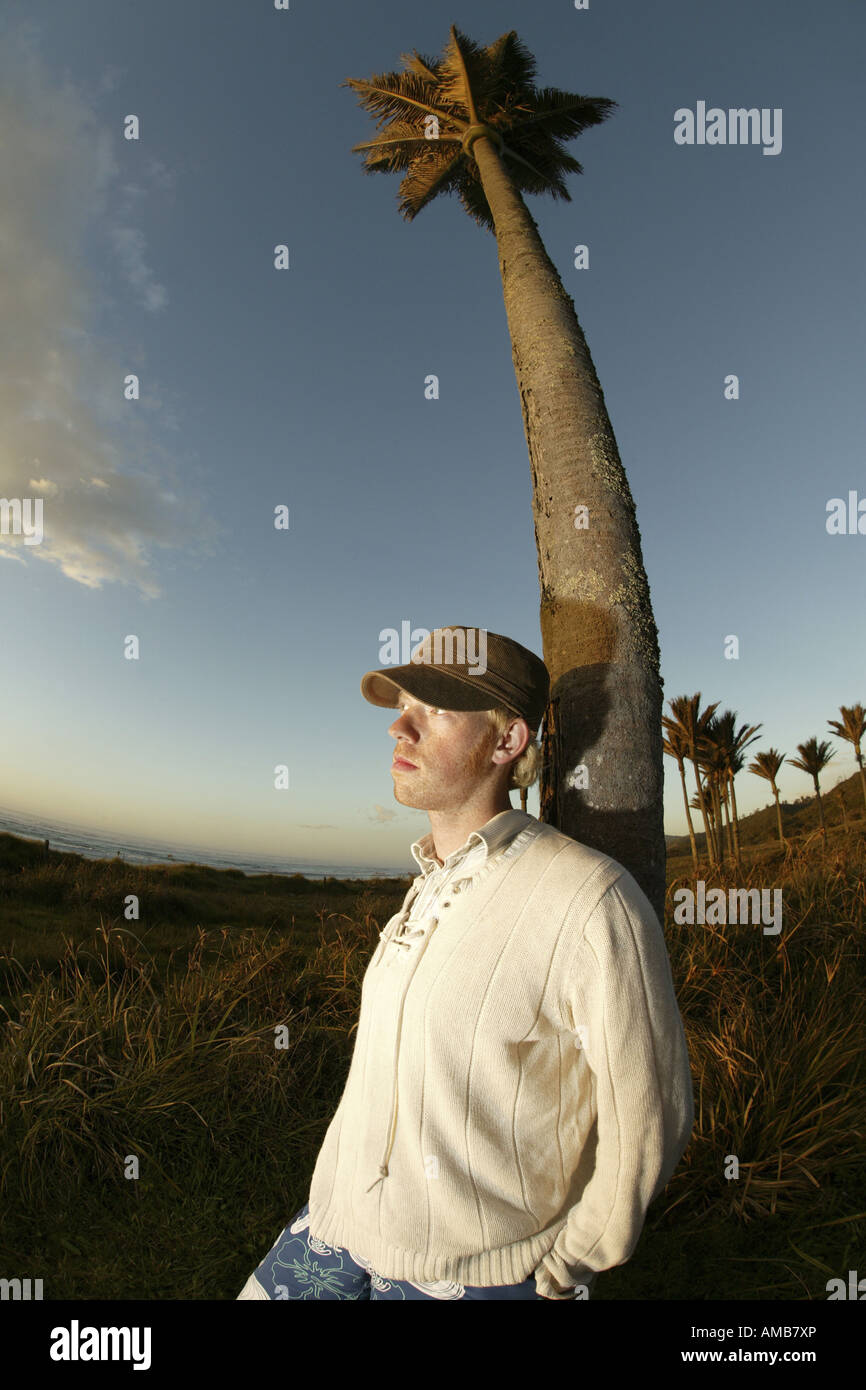 Young blond man leaning against palm tree hi-res stock photography and ...