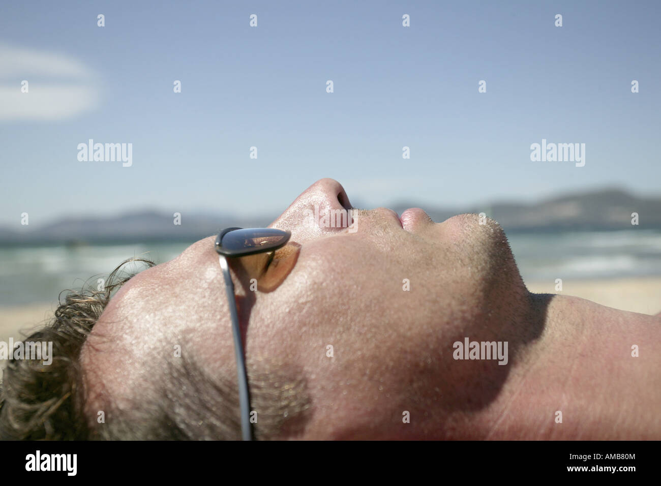 portrait of a man lying in the sun Stock Photo - Alamy