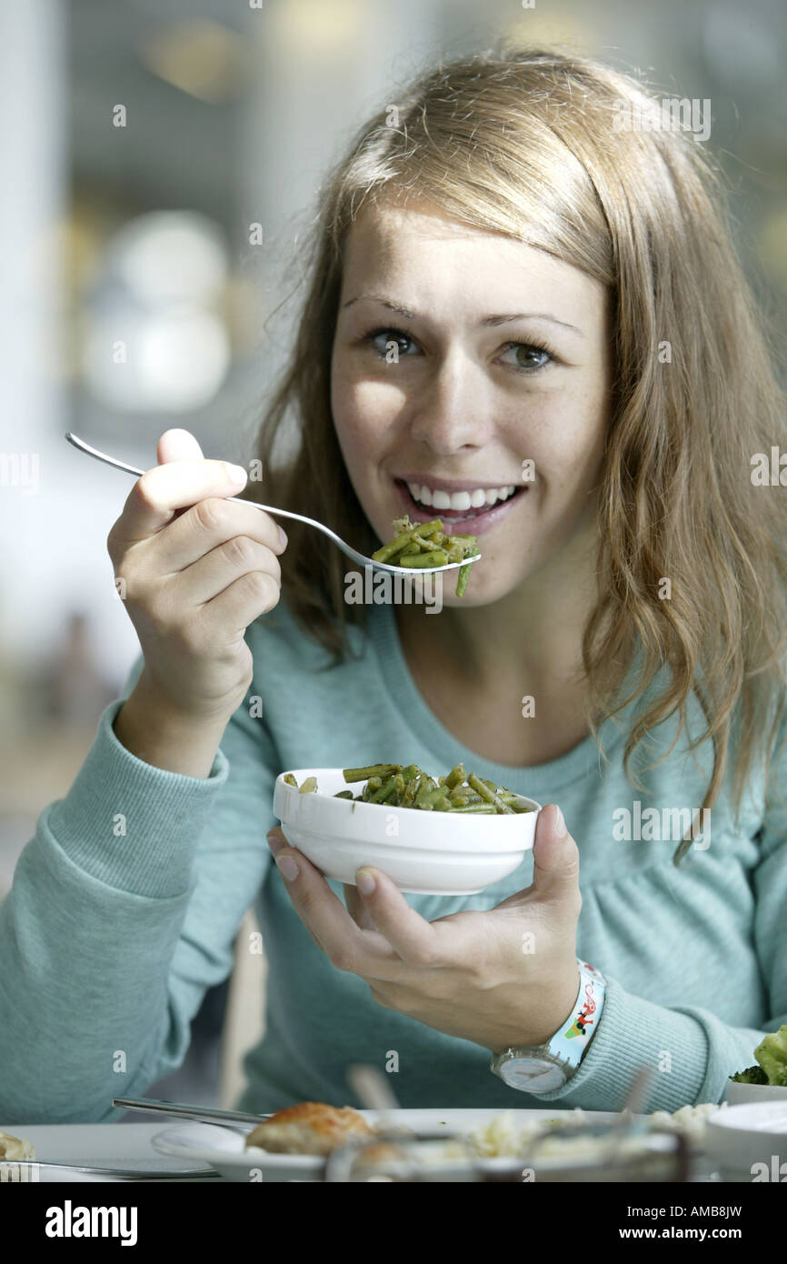 young woman eating beans in refectory of Ruhr-Universitaet Bochum ...