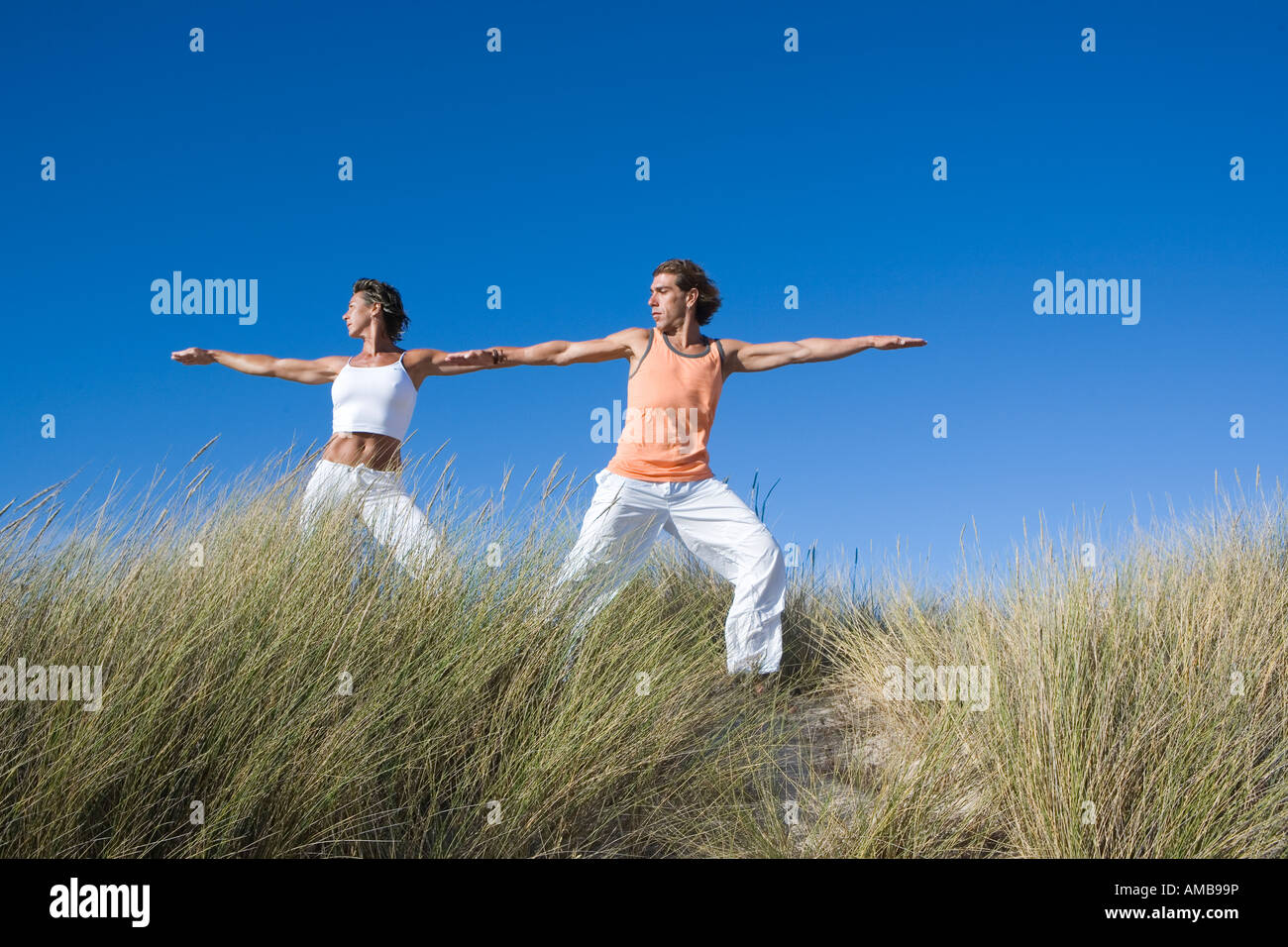 woman and man practice yoga positions together Stock Photo - Alamy