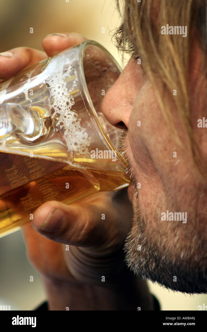 man drinking off a beer glas Stock Photo - Alamy