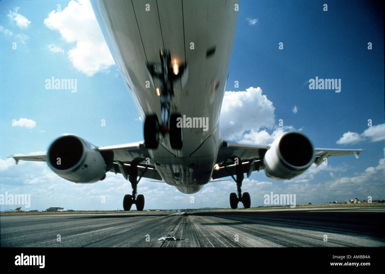 Head on close view of civil aircraft touching down on the runway Stock ...