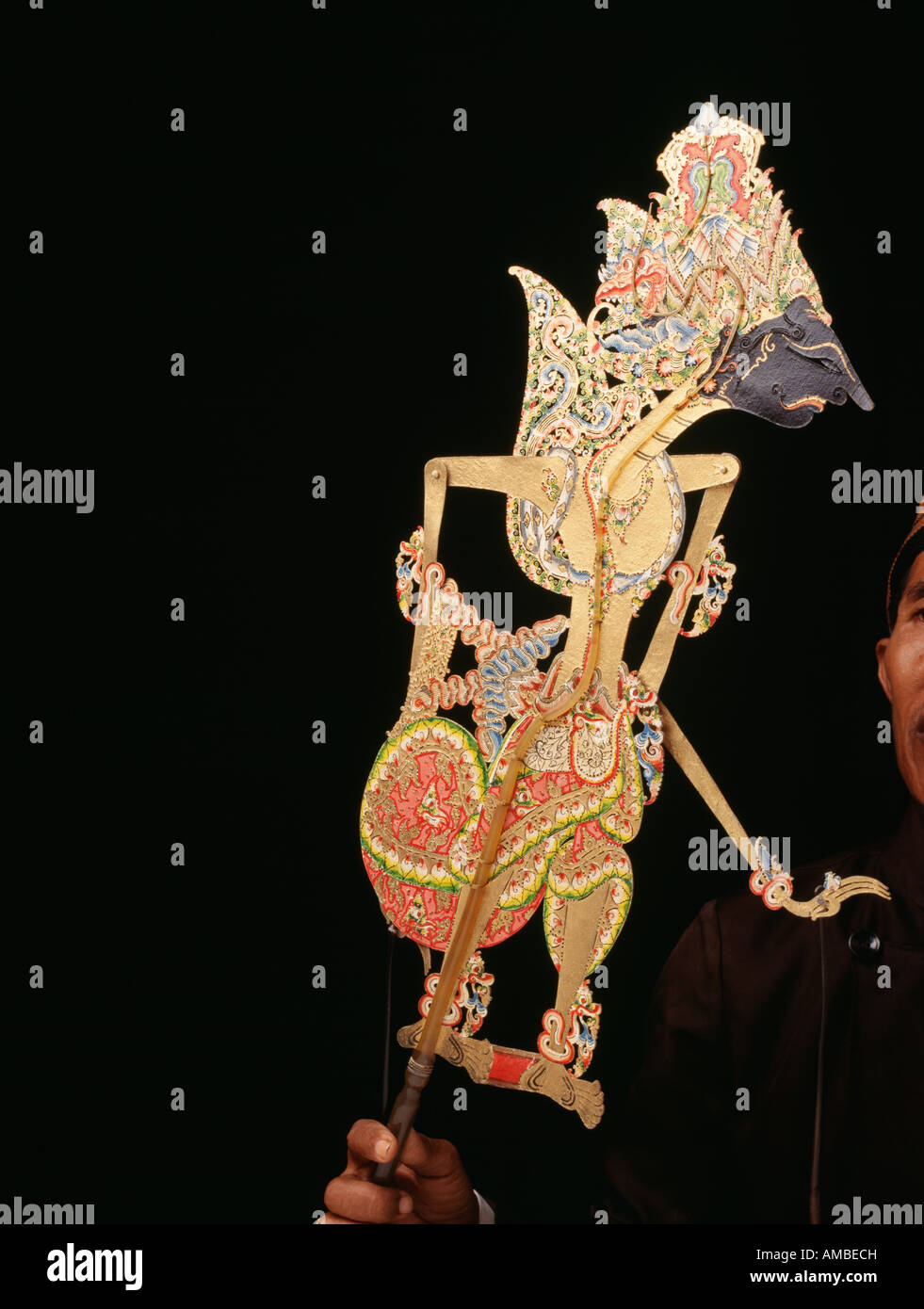 Wayang puppet master with shadow puppet Stock Photo - Alamy