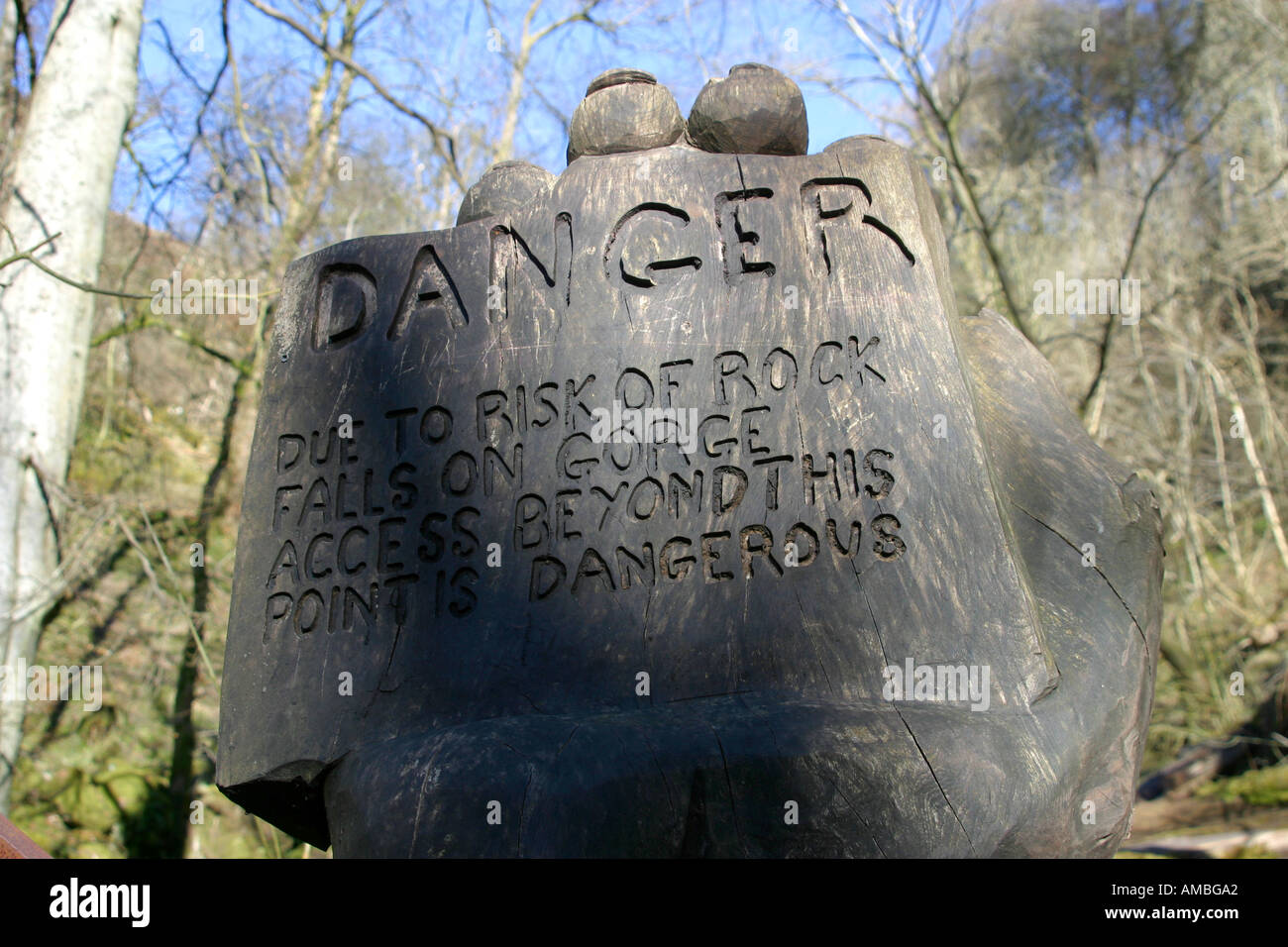 Warning sign carved from tree stump Stock Photo - Alamy
