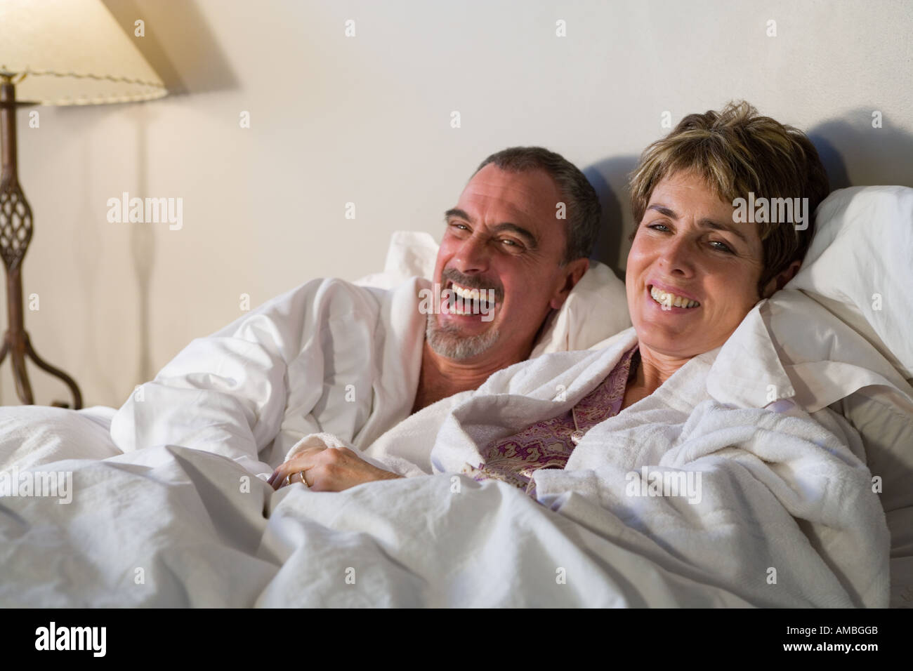 50 year old couple in bed laughing Stock Photo - Alamy