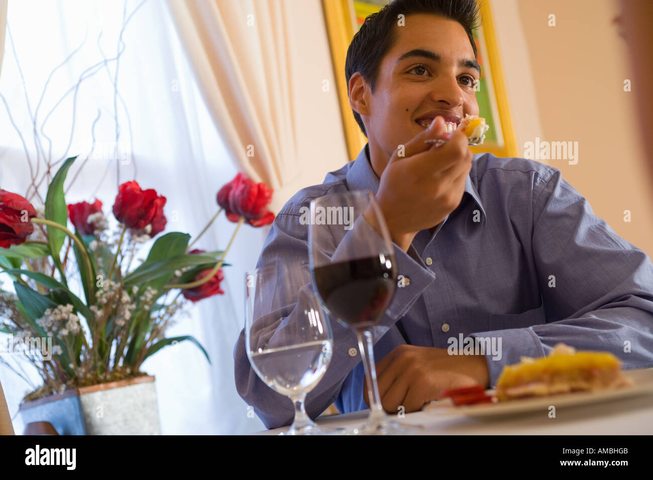 young man eating meal in restaurant Stock Photo - Alamy