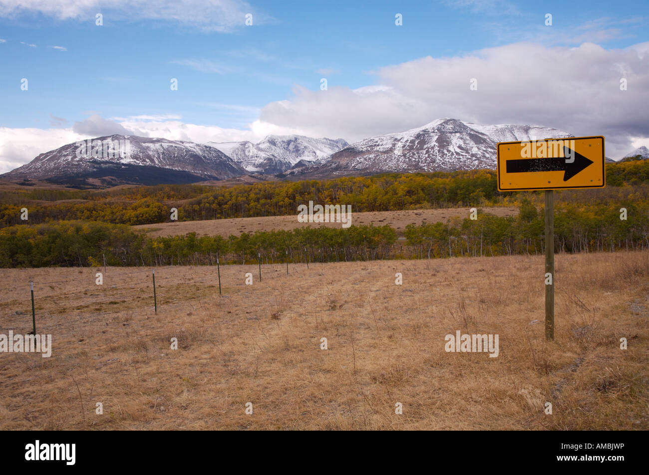 Rocky Mountain Front and highway arrow sign Near Glaciern National Park ...