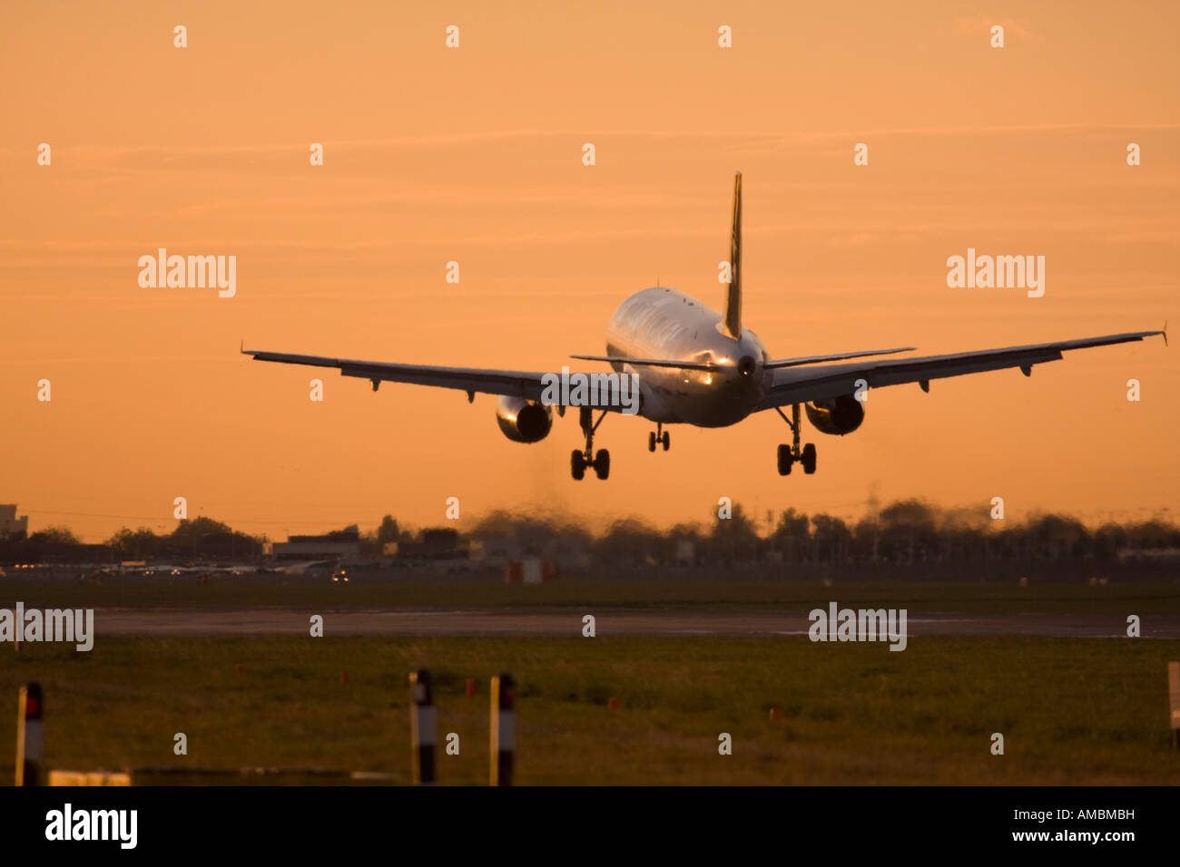 Airplane landing at airport Stock Photo - Alamy