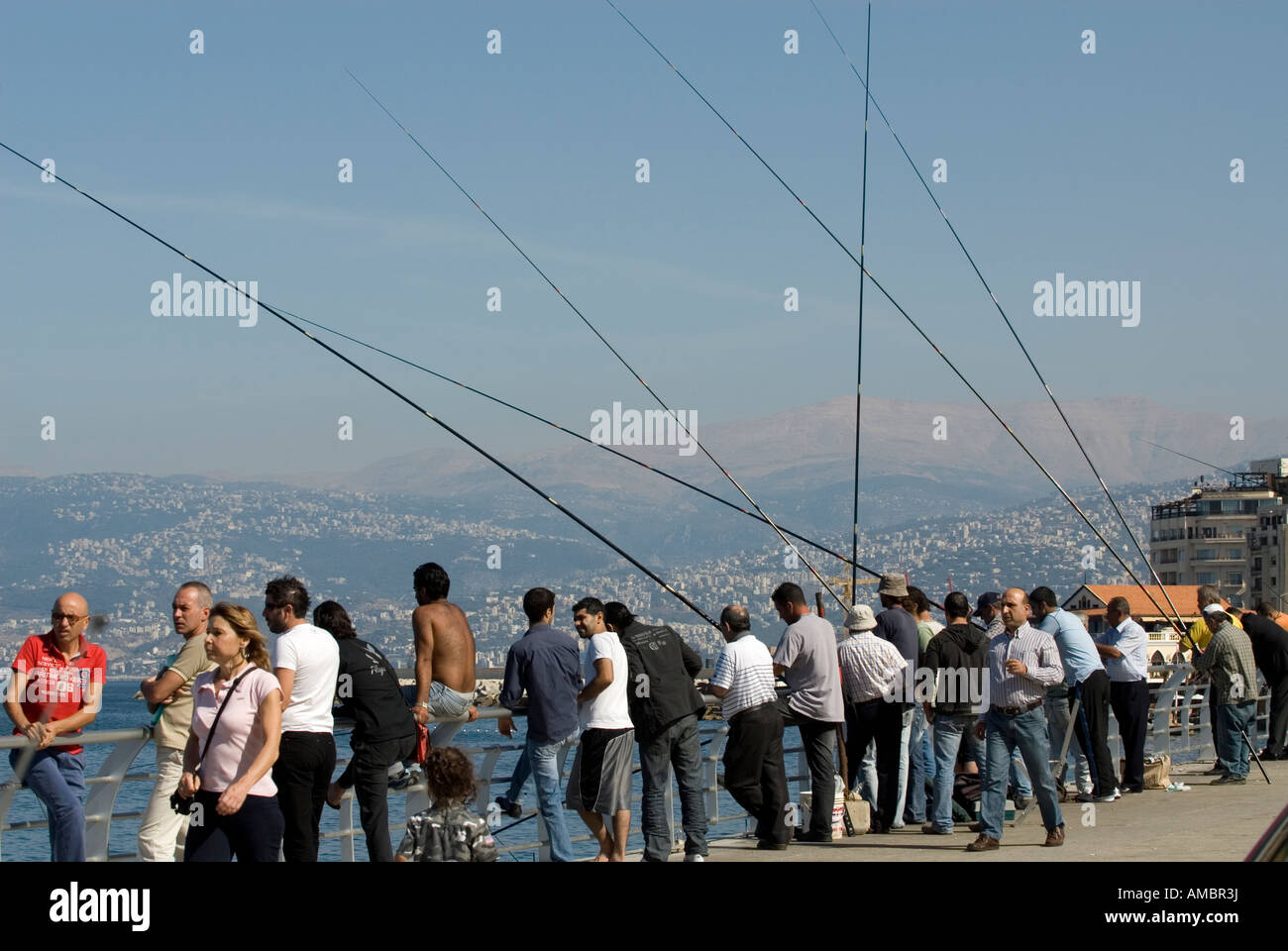 people fishing by sea shore Stock Photo - Alamy