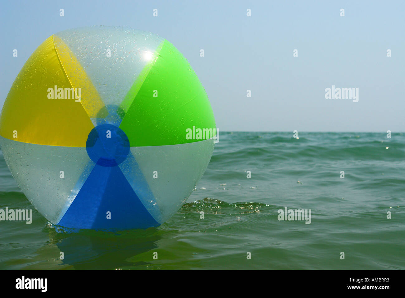 Beach ball at the ocean Stock Photo - Alamy