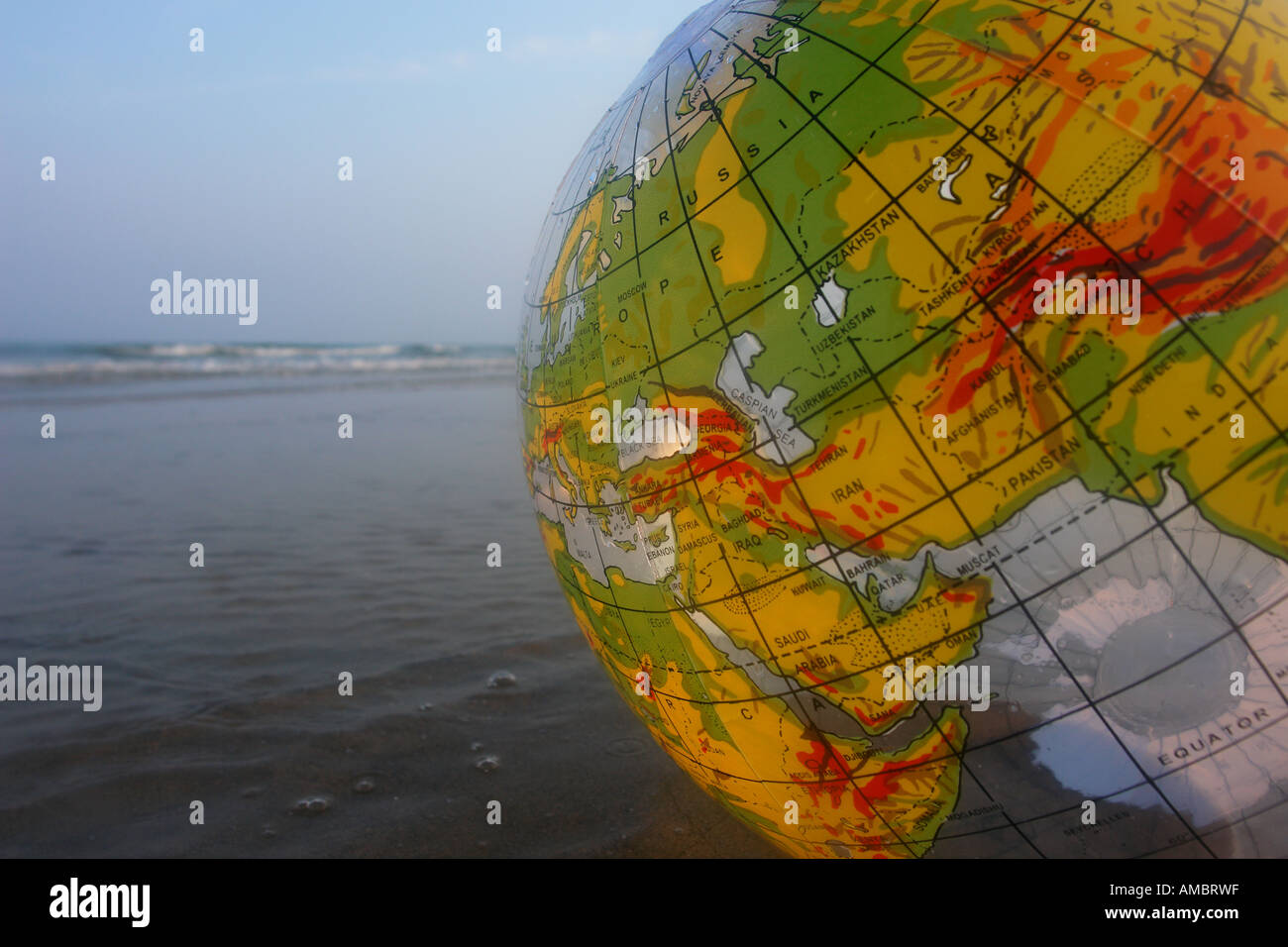 Globe ball at the ocean Stock Photo - Alamy