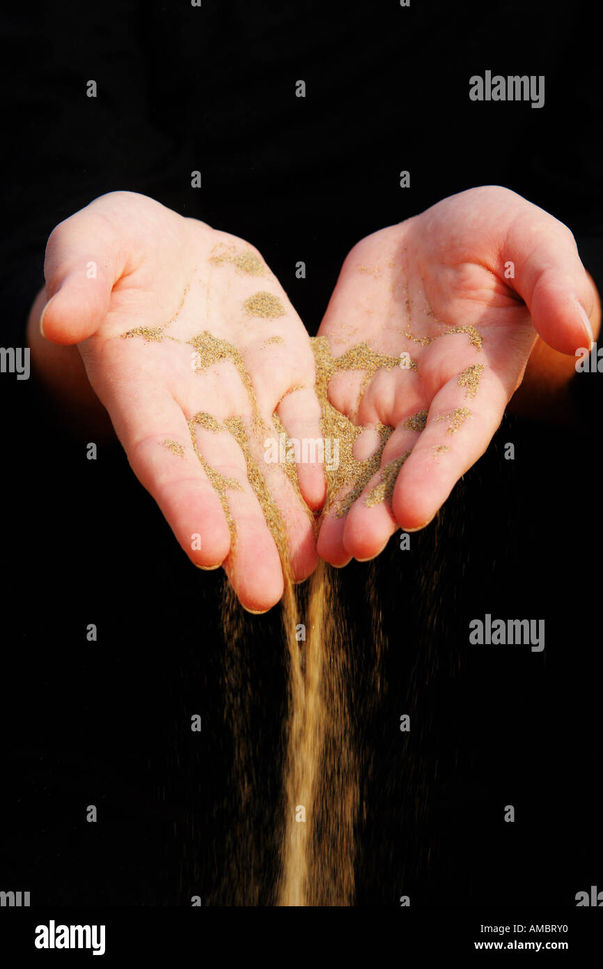 sand running through hands as a symbol for time running lost etc Stock ...