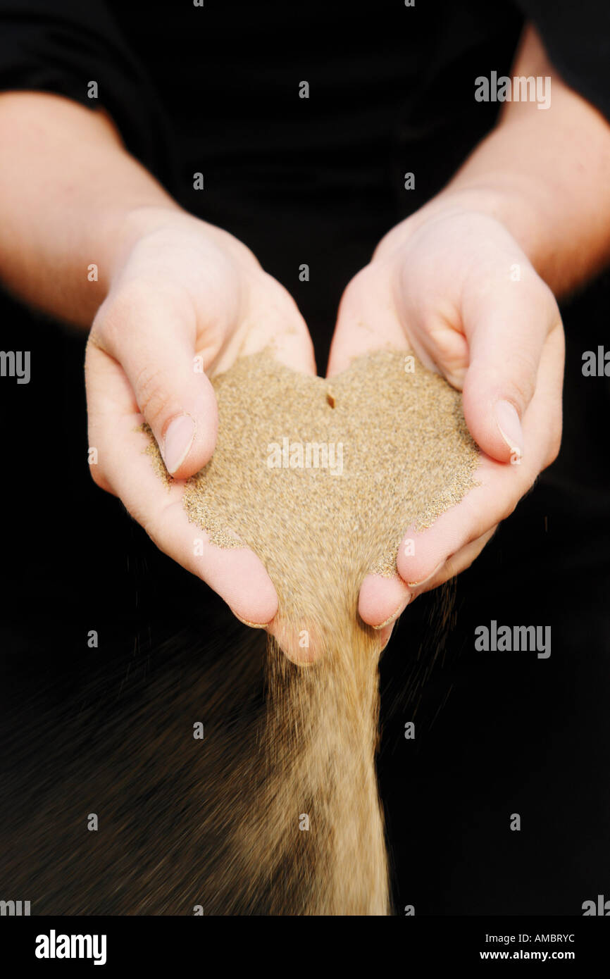 sand running through hands as a symbol for time running lost etc Stock ...