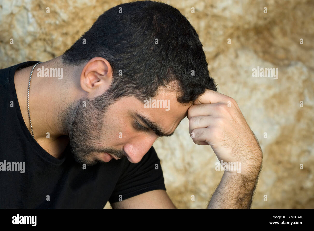 sad young man hand on head Stock Photo - Alamy