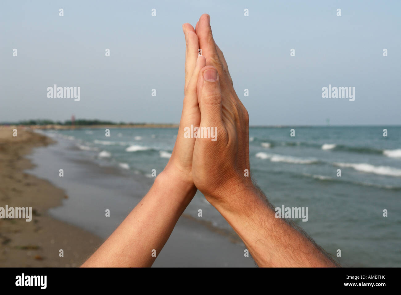 Hands beach ocean pray hi-res stock photography and images - Alamy