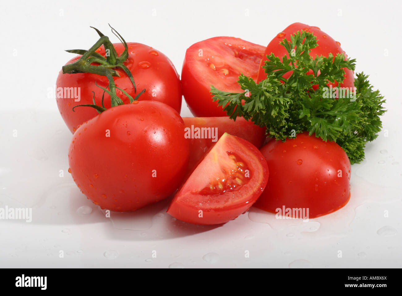 Ripe red tomatoes whole and half quarter vegetables nobody overhead top view closeup horizontal ...