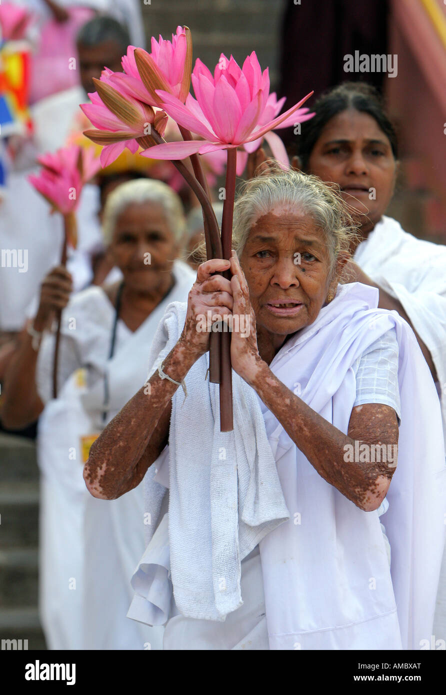 India, Bodhgaya: buddhist pilgrims with lotus flowers visiting the ...