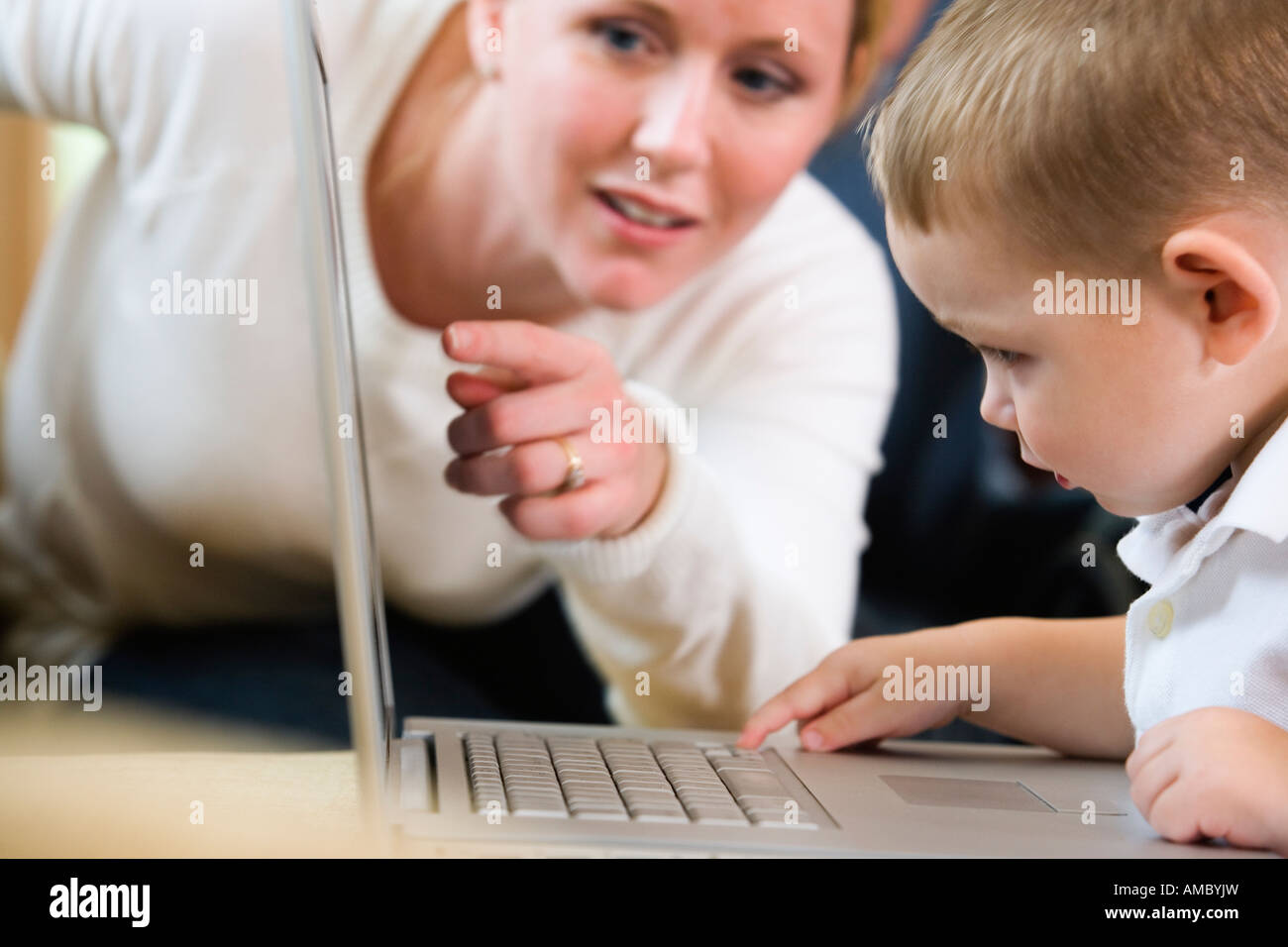 View of a mother teaching her son to use the computer Stock Photo - Alamy