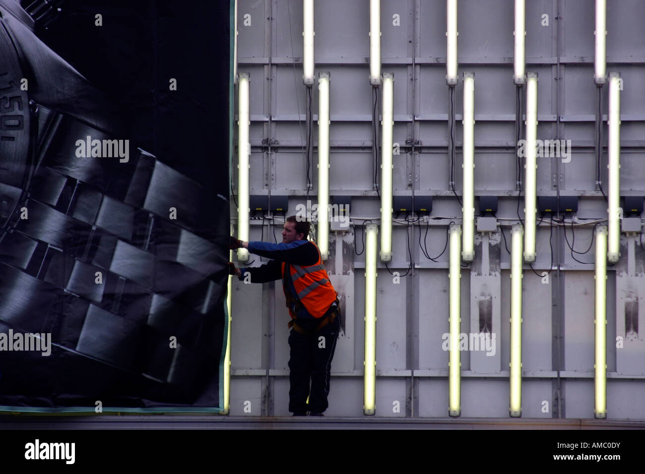 man pulling backlit advertising hoarding onto display board Stock Photo ...