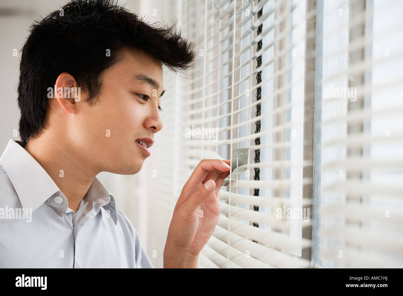 A man looking out from a window Stock Photo - Alamy