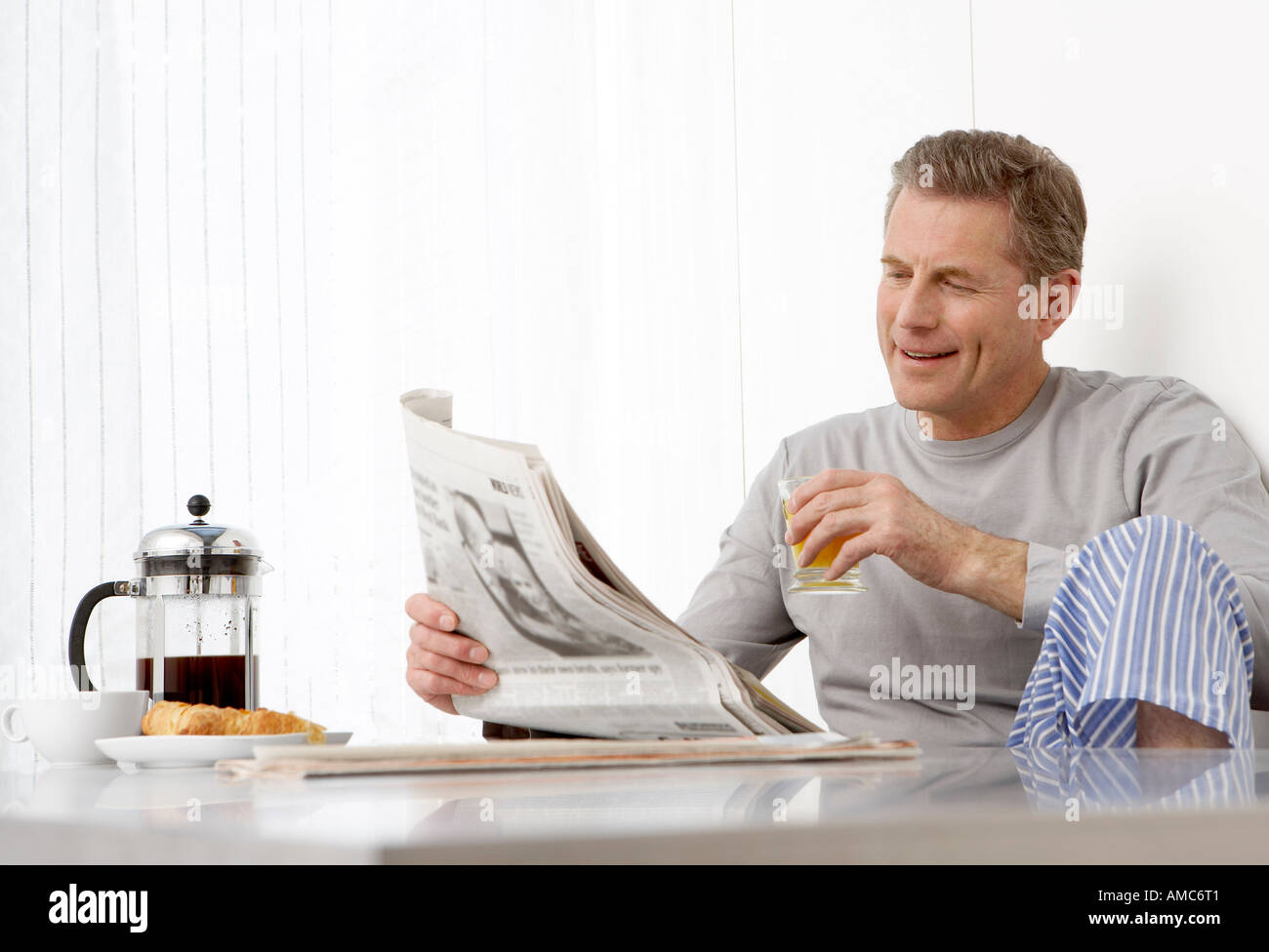 Portrait smiling man sitting breakfast table newspaper hi-res stock ...