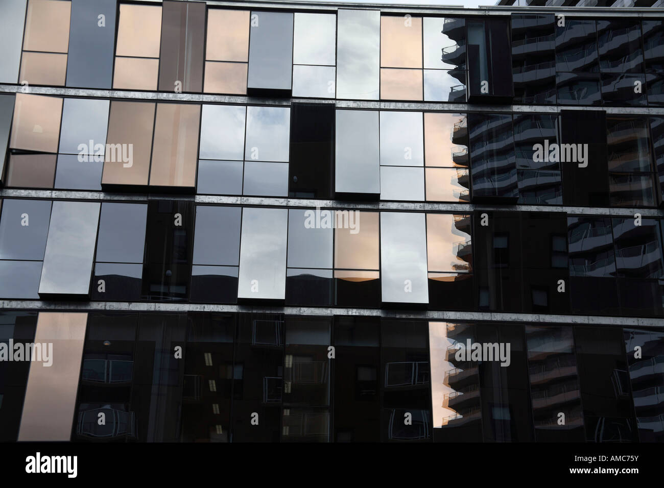Reflections in tinted glass commercial building Stock Photo - Alamy
