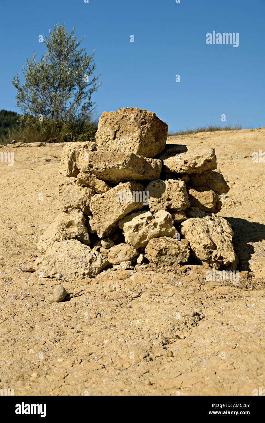 piles of rock mud and stone on the dry shores of lac de montbel in the ...